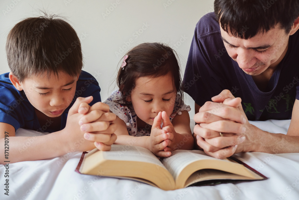 parent and children praying at home, family worship online together ...