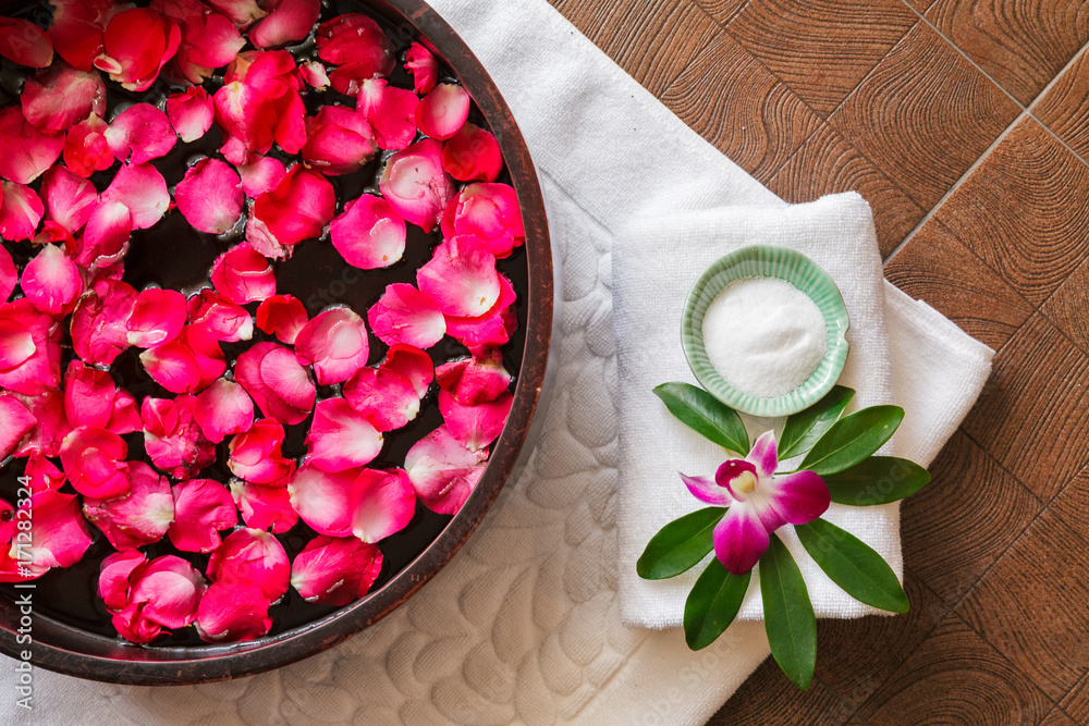Spa pedicure treatment with foot bath in bowl, red rose petals ,orchid ...