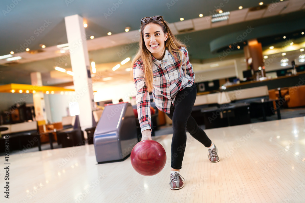Focused happy woman enjoying bowling Stock Photo | Adobe Stock