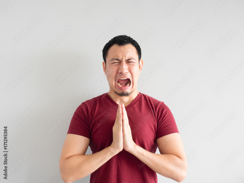 Sad man begging for forgiveness. Stock Photo | Adobe Stock