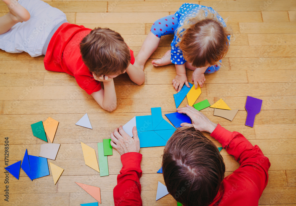 teacher and kids playing with geometric shapes Stock Photo | Adobe Stock