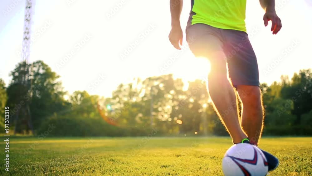 close up legs and feet of football player in action wearing black shoes ...