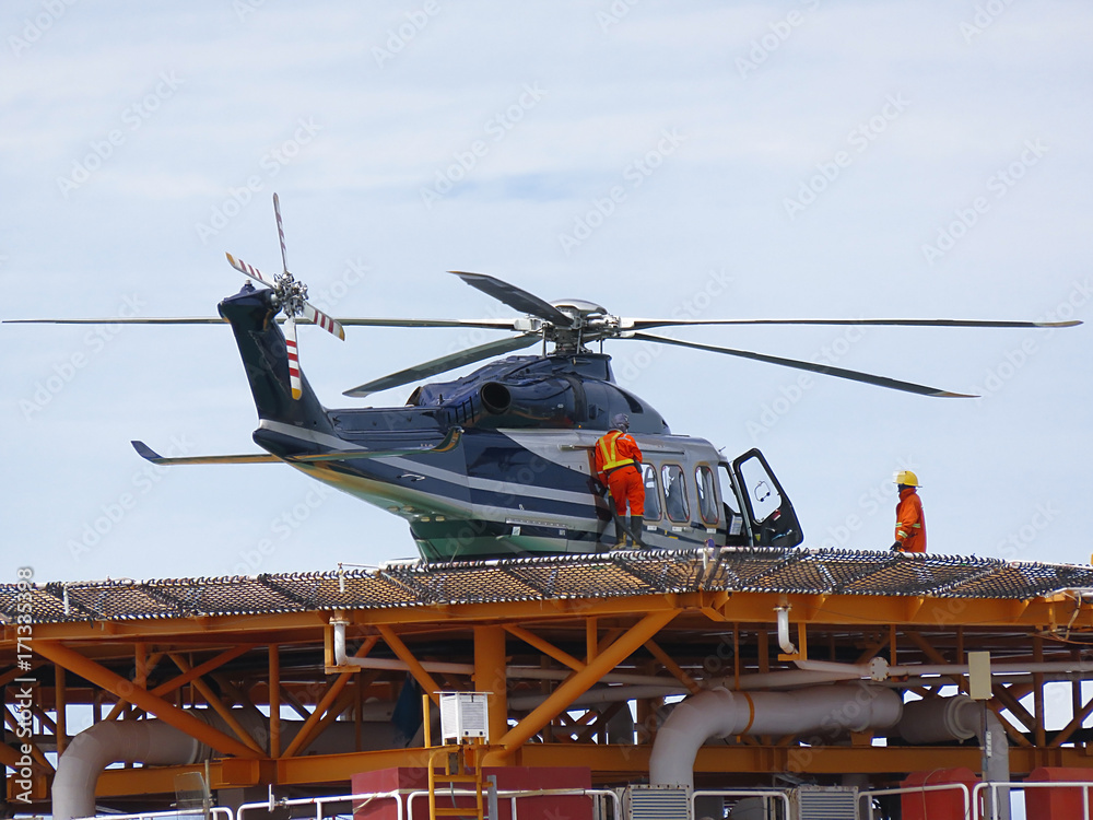 Helicopter or chopper land at oil and gas platform area for get and ...
