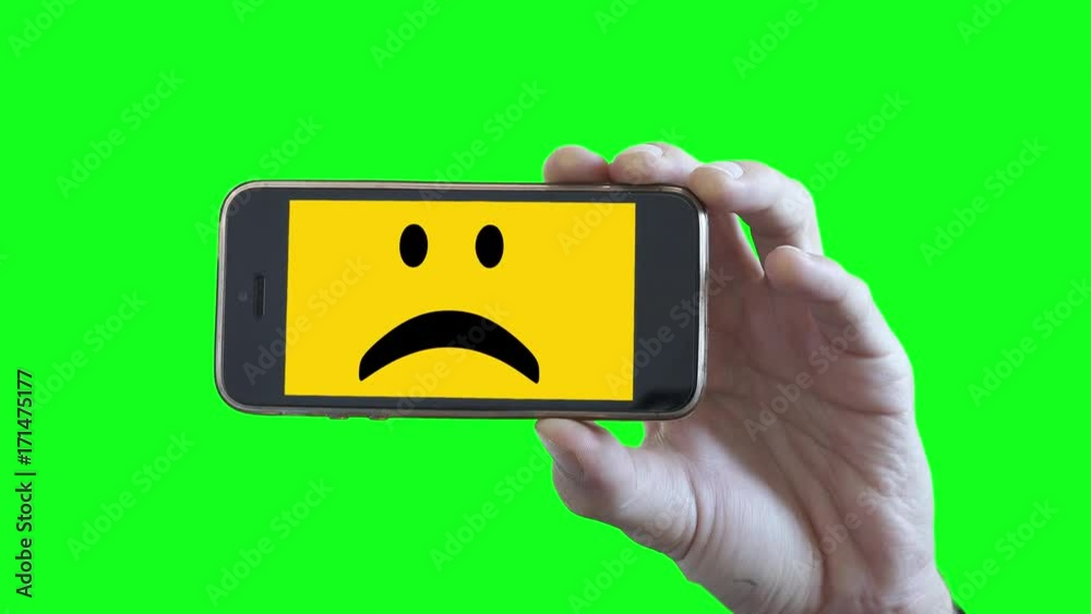 Sad Face Smartphone On Green Screen Background. Male hand holding a ...