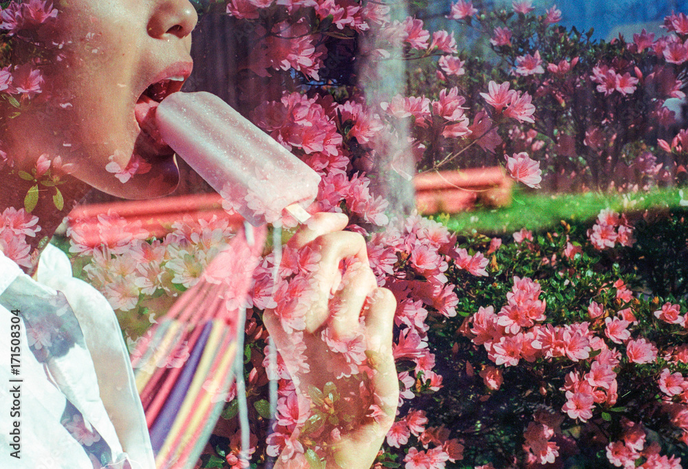 Pretty asian girl eating a pink popsicle on a warm summer day ...