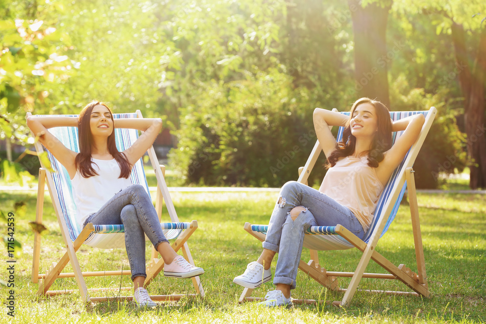 Beautiful young women sunbathing in park Stock Photo | Adobe Stock