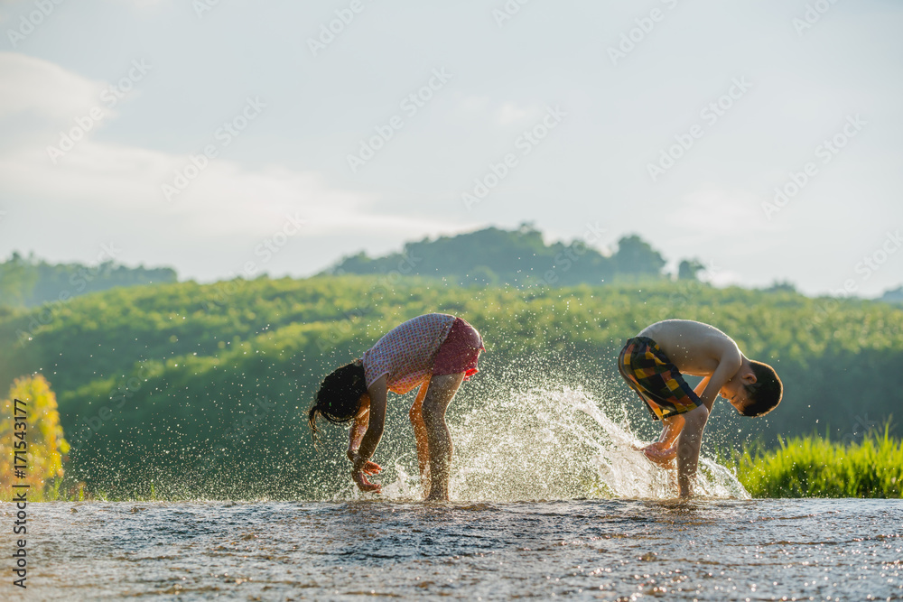 asian children playing splashing water in the river. Stock Photo ...