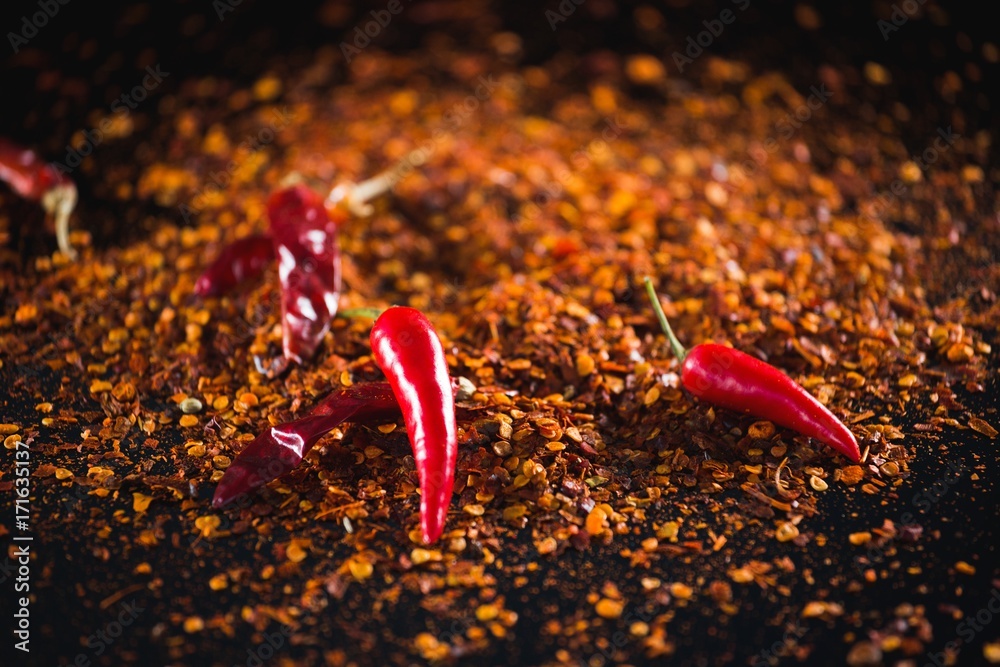 Red chilli flakes against black background Stock Photo | Adobe Stock