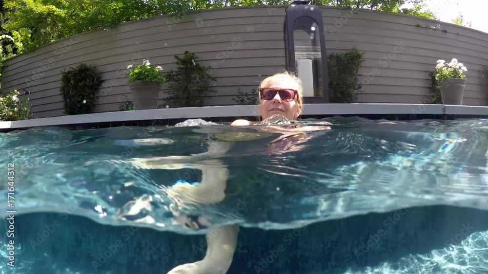 Camera half above and half below water, a beautiful, slim, caucasian ...