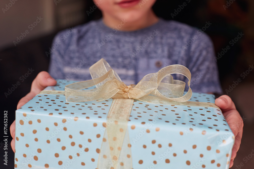 Child holding a present Stock Photo | Adobe Stock