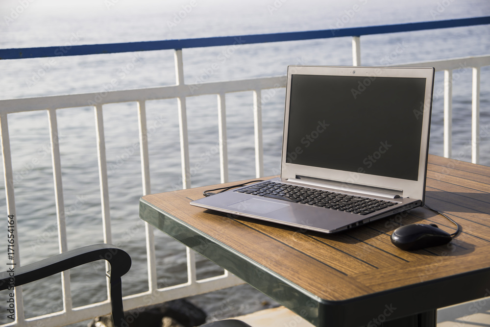 workplace on the beach. computer with a black screen on the desk Stock ...