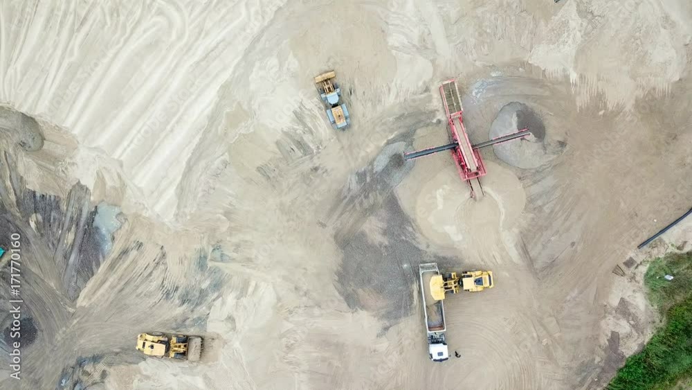Excavator loader in sand quarry. View from above. Aerial view dumper ...