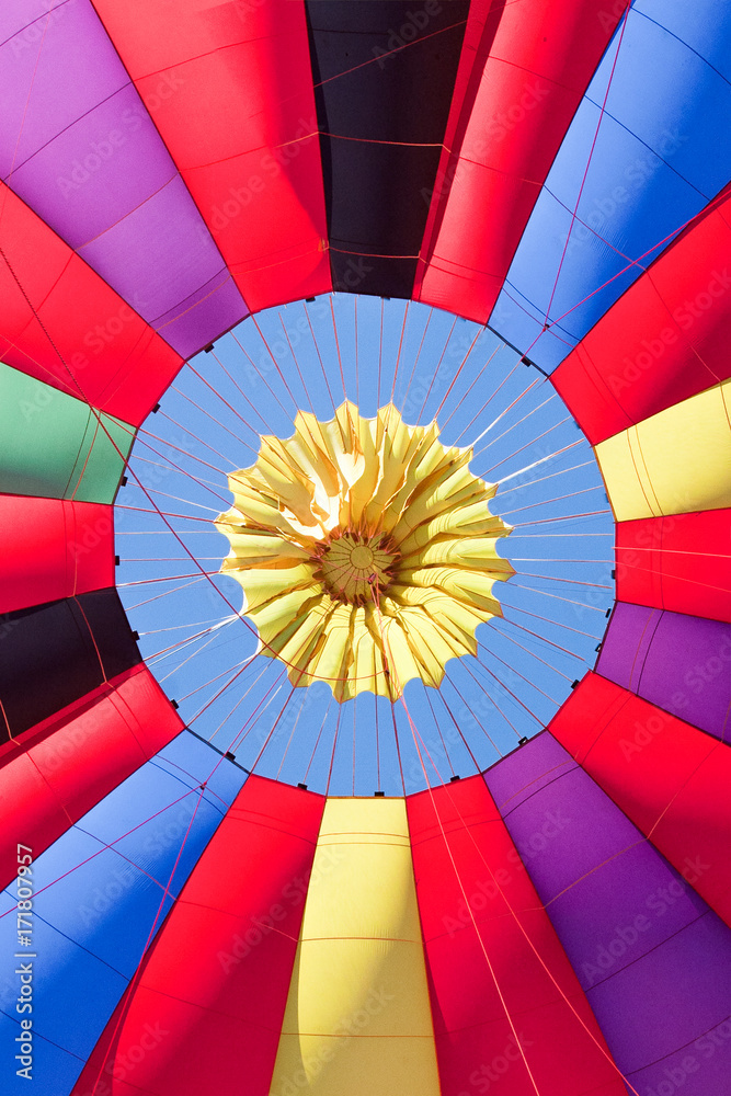 Looking up into the top of a hot air balloon venting air to descend ...