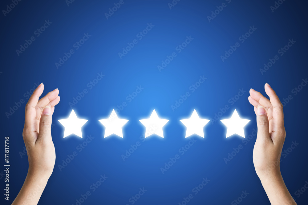 Hand holding five star symbol to increase rating of company with dark ...