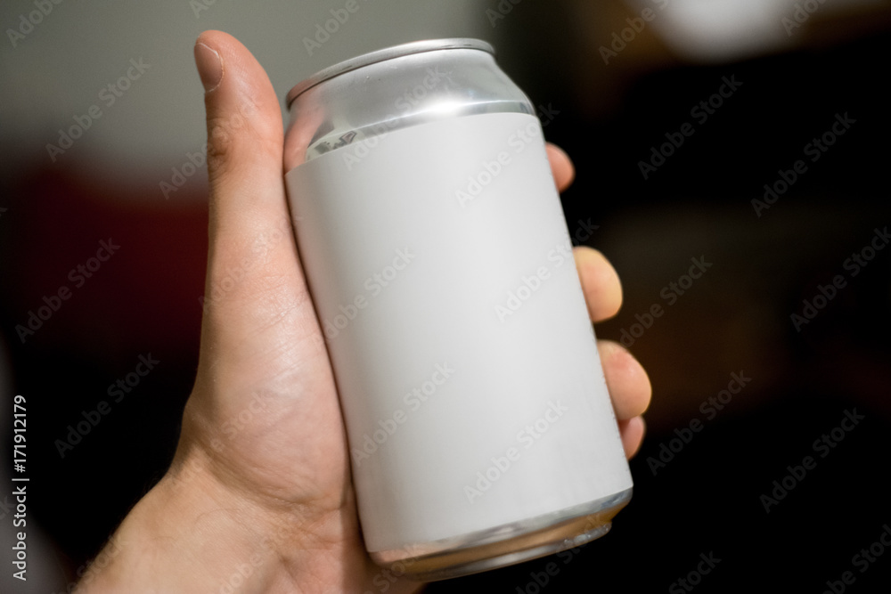 Hand holding a blank can Stock Photo | Adobe Stock