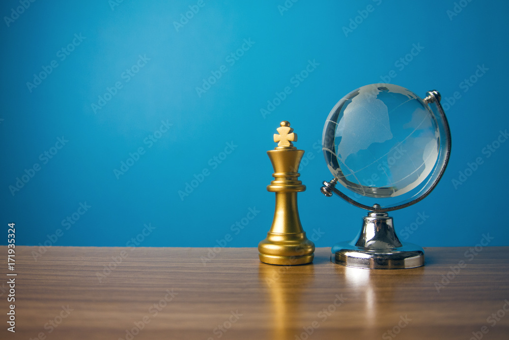 global earth world with king chess gold on blue background in business ...