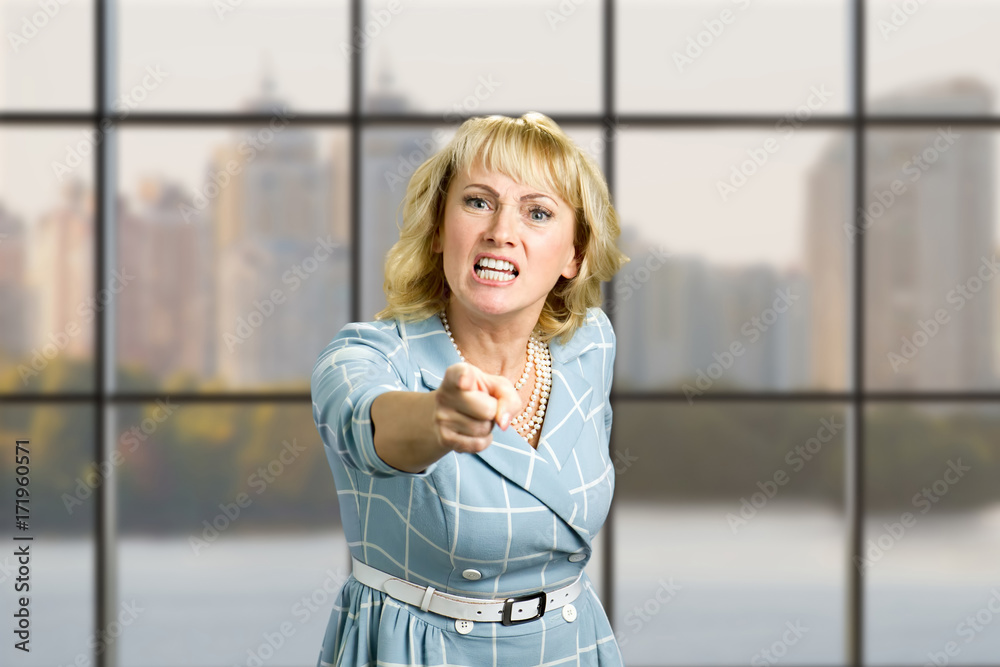 Angry mature woman pointing forward. Frustrated middle aged woman ...