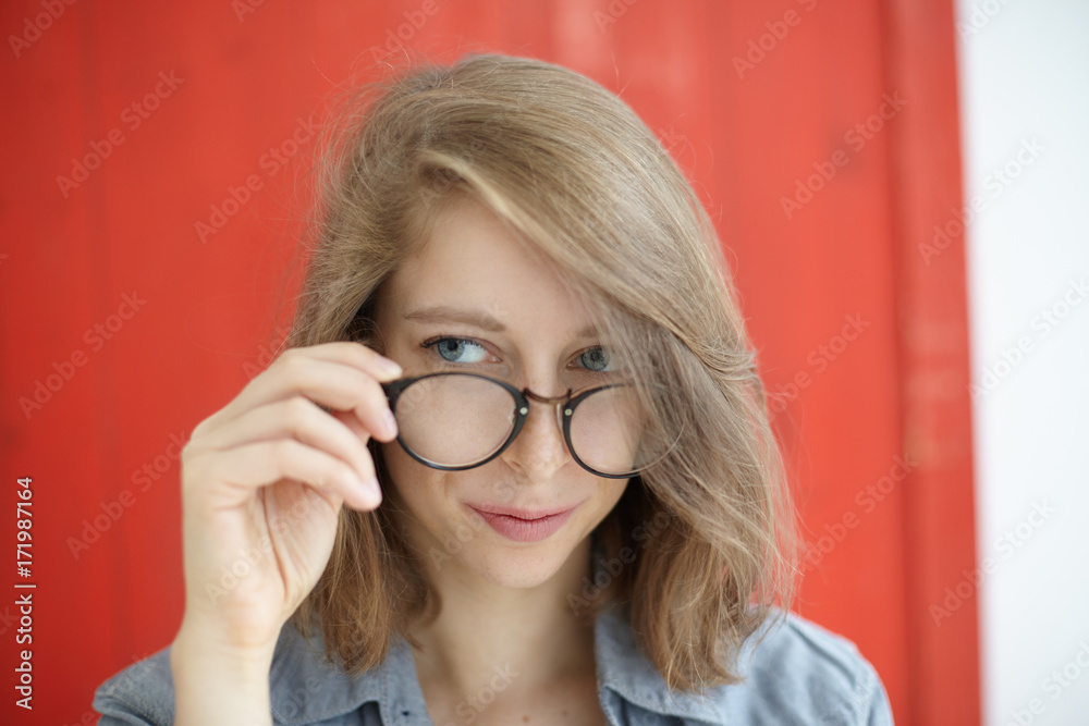 Portrait of beautiful young female teacher with blue eyes, freckles and ...
