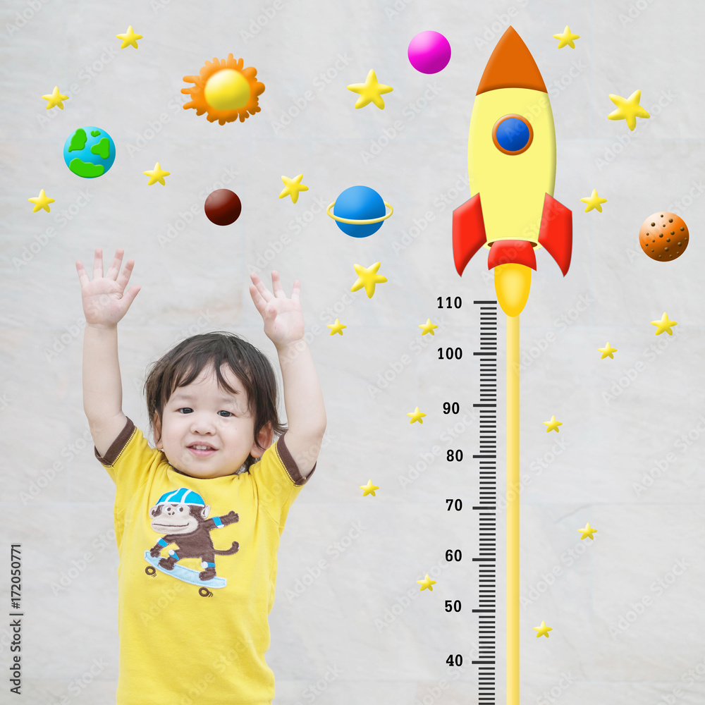Closeup happy asian kid stand for measure height with cute cartoon at ...