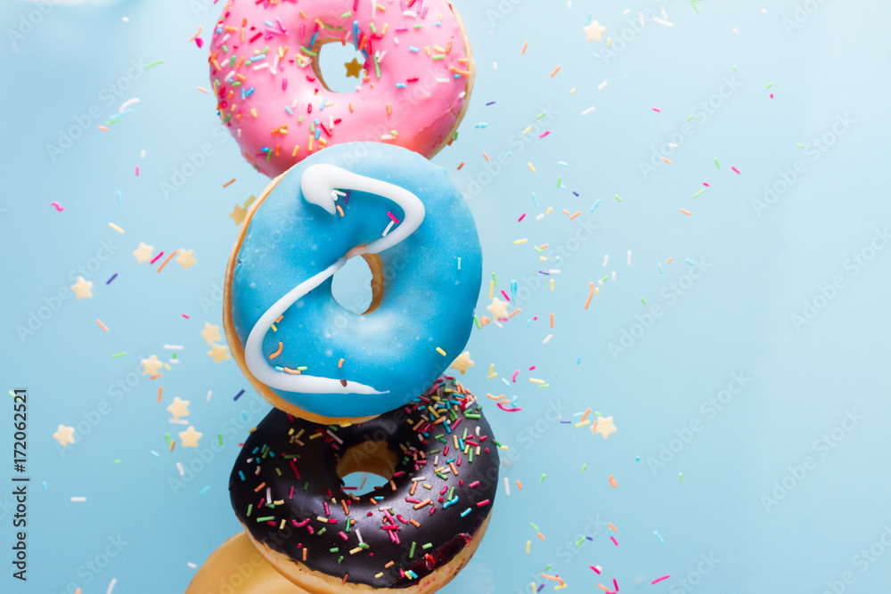 flying doughnuts border - mix of multicolored sweet donuts with ...