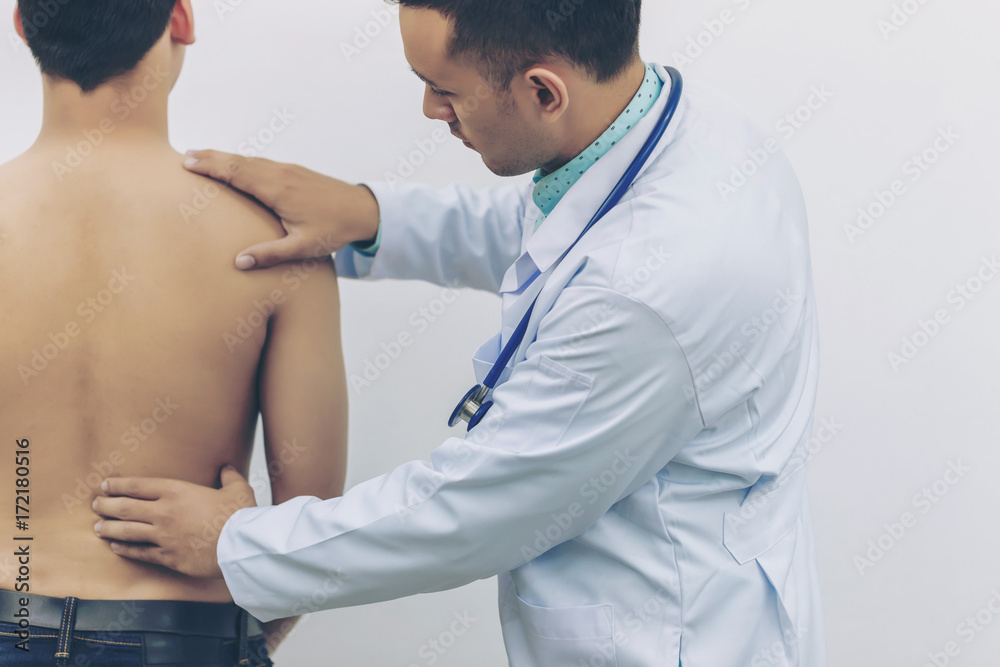 Doctor touches the back plate for causes of back pain with stethoscope ...