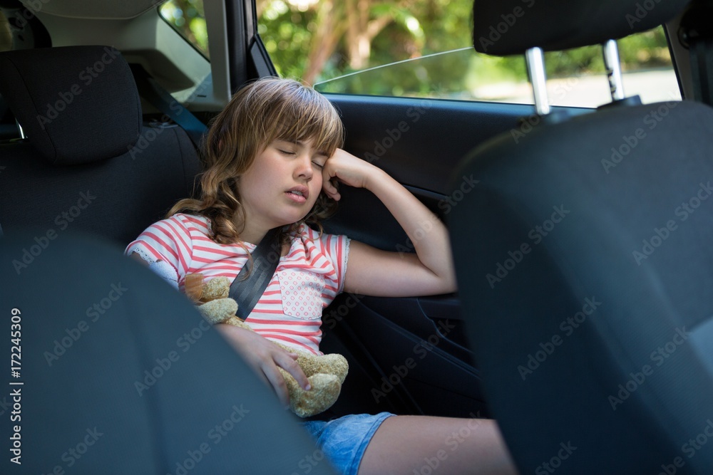 Teenage girl sleeping in the back seat of car Foto Stok | Adobe Stock