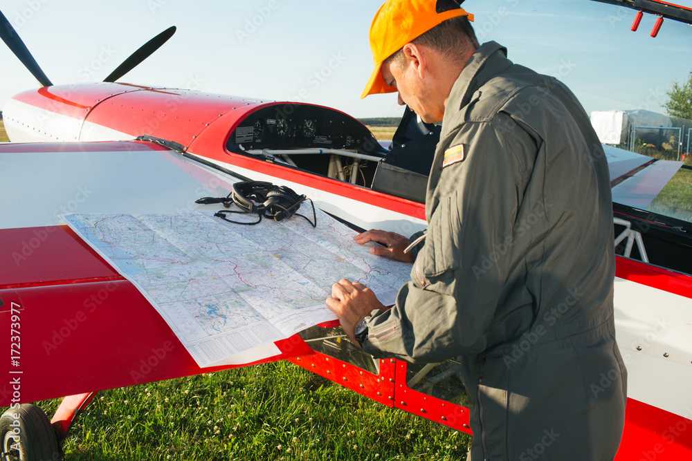 Pilot exploring map on airplane Stock Photo | Adobe Stock