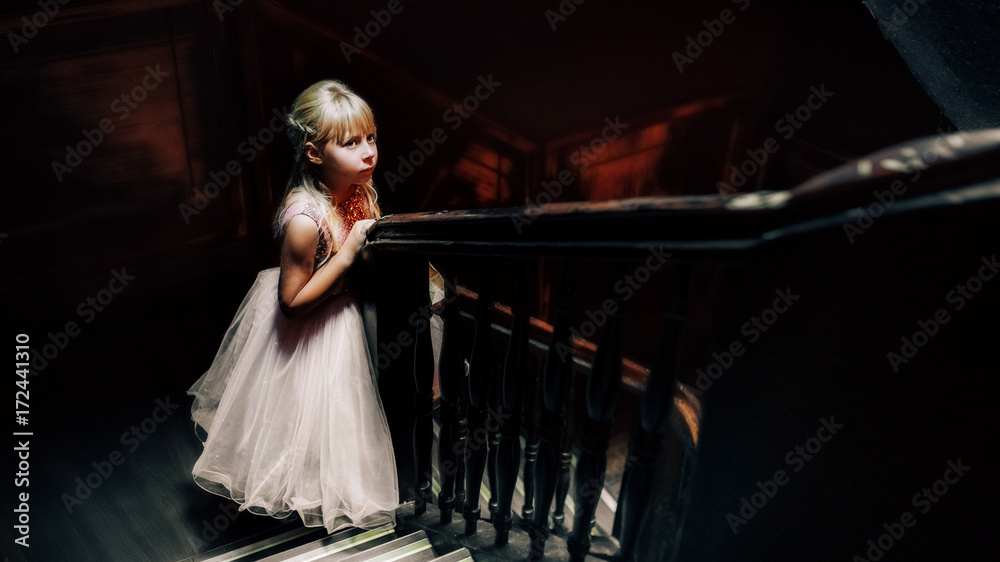 little princess in an old castle.a little girl with blond hair in a ...