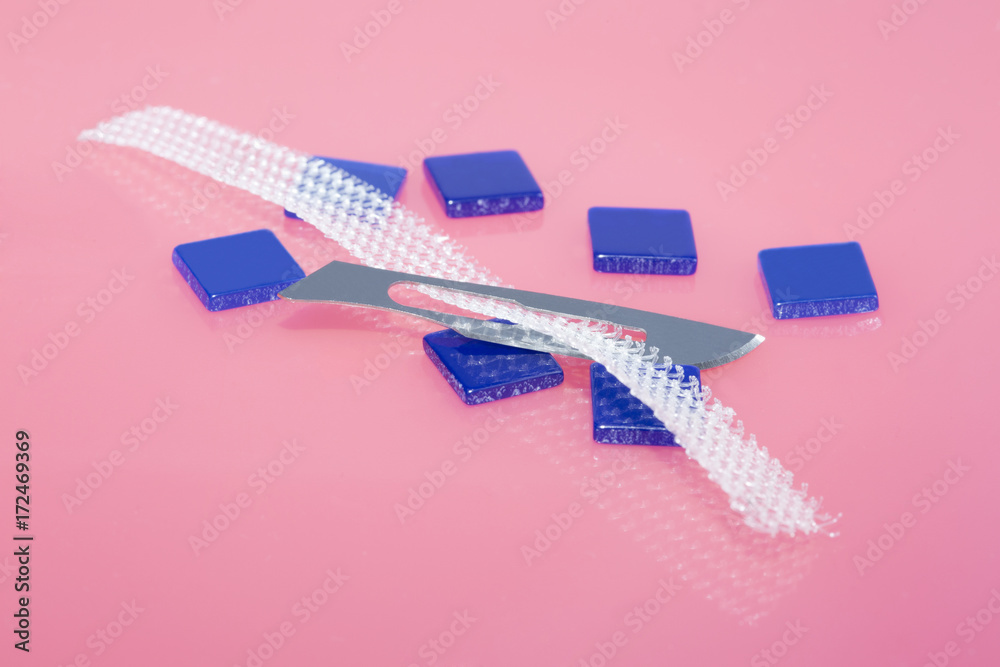 TVT surgery concept. Piece of tension-free vaginal tape and surgical ...
