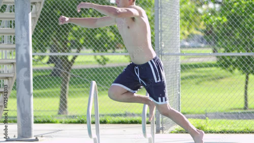Young man jumping into a pool Stock Video | Adobe Stock