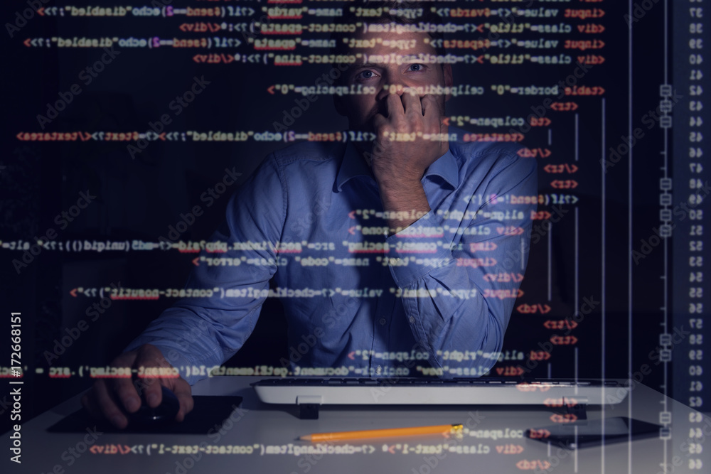 programmer working with programming code on computer screen in dark ...
