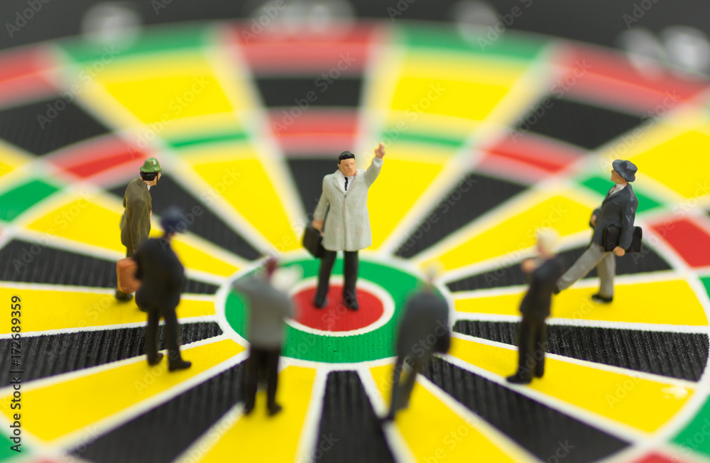 Miniature people: Businessman with glass chess on the target center of ...