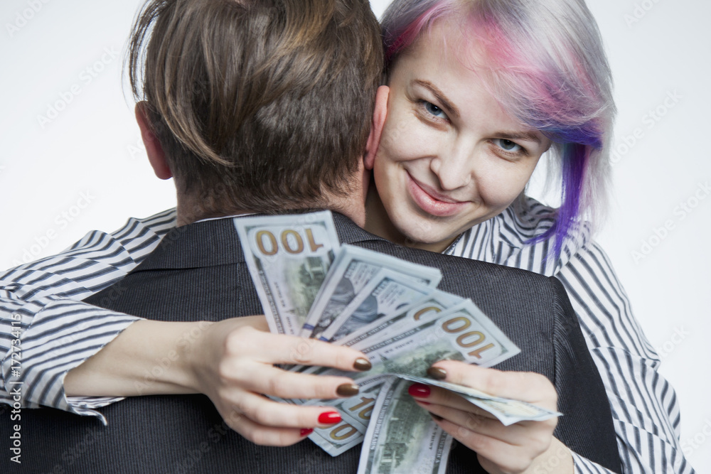 Money Over Love. Woman hugs her husband and counts money. (Gender ...