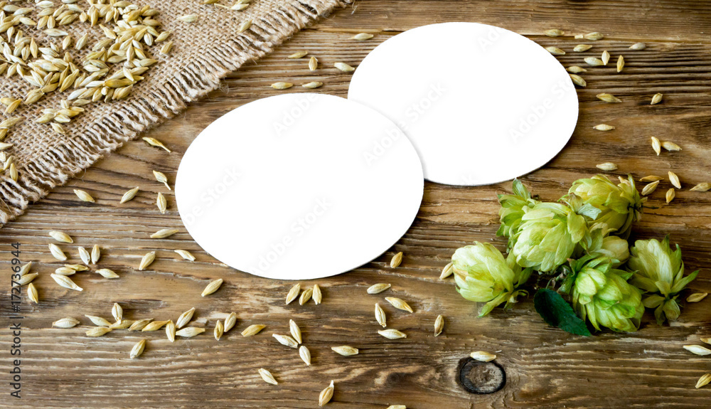 Two blank beer coasters on wooden rustic table background with cloth ...