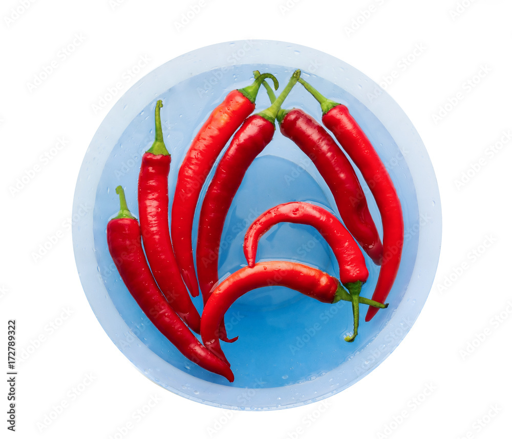 Red cayenne peppers (Capsicum annuum) in bowl of water isolated on ...