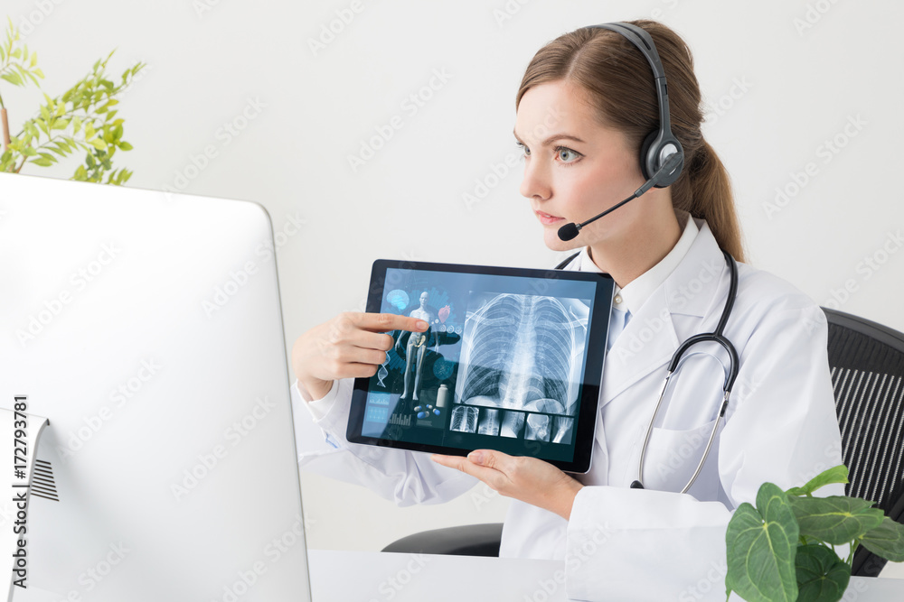 Remote medicine concept. Young woman doctor talking with a TV phone ...