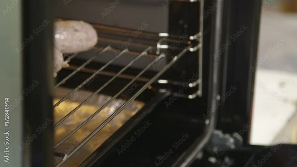 Cooking roasted sausage baked on roasting rack in the oven. Chef ...