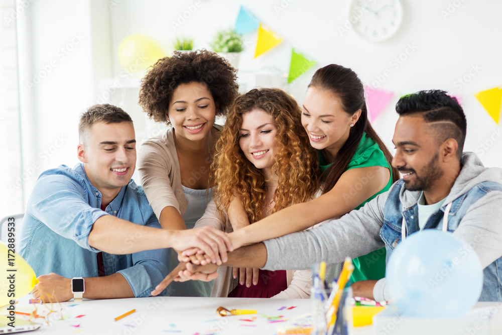 happy team at office party holding hands together Stock Photo | Adobe Stock