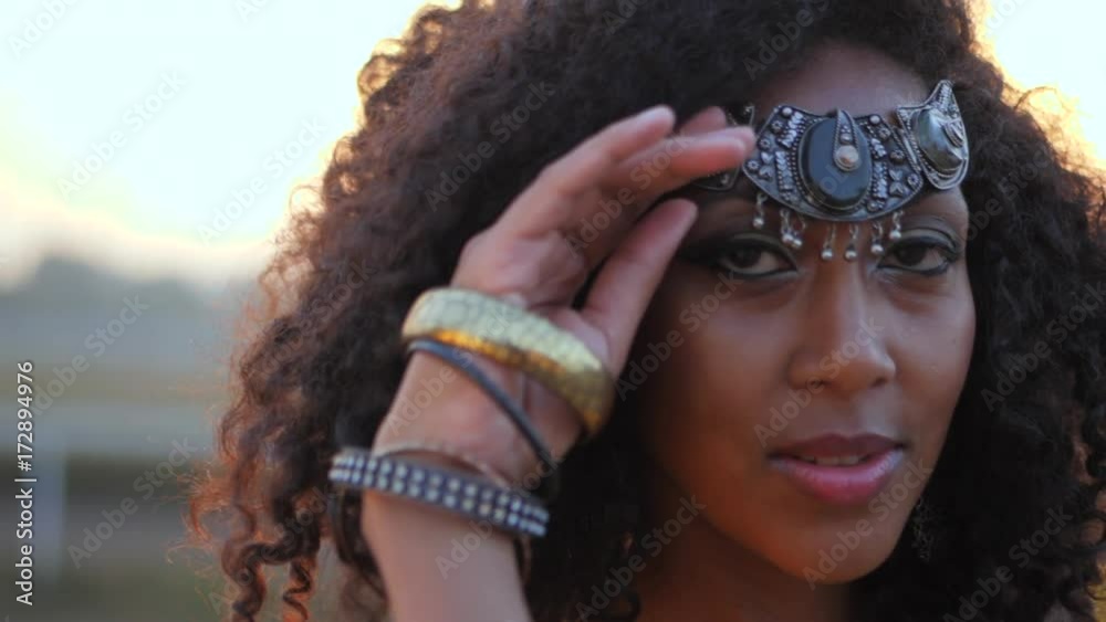 Portrait of young afro-american gypsy woman in colorful yellow ...