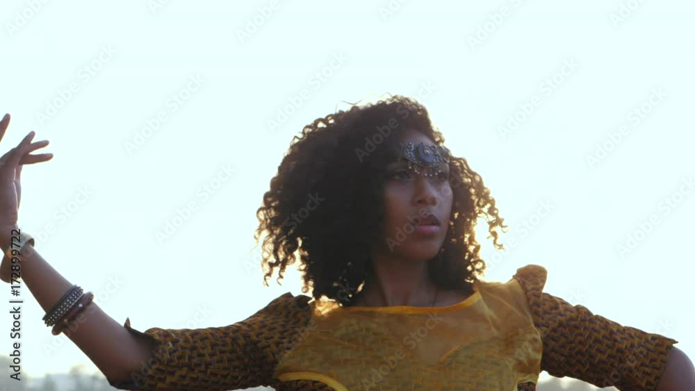 Portrait of young afro-american gypsy woman in colorful yellow ...