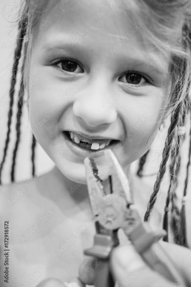 Monochrome photo of a little girl without a single tooth and her father ...