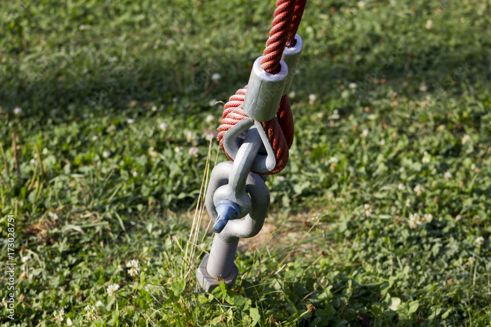 Eye bolt secures cable to the ground Stock Photo | Adobe Stock