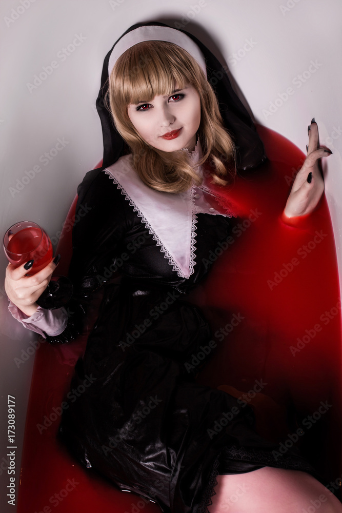 A woman nun is lying in the bathroom in the blood and drinking blood ...