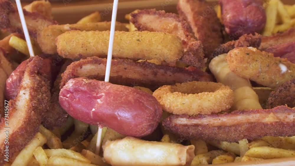Sausages, onion rings, fried chicken, schnitzel and french fries. Food ...