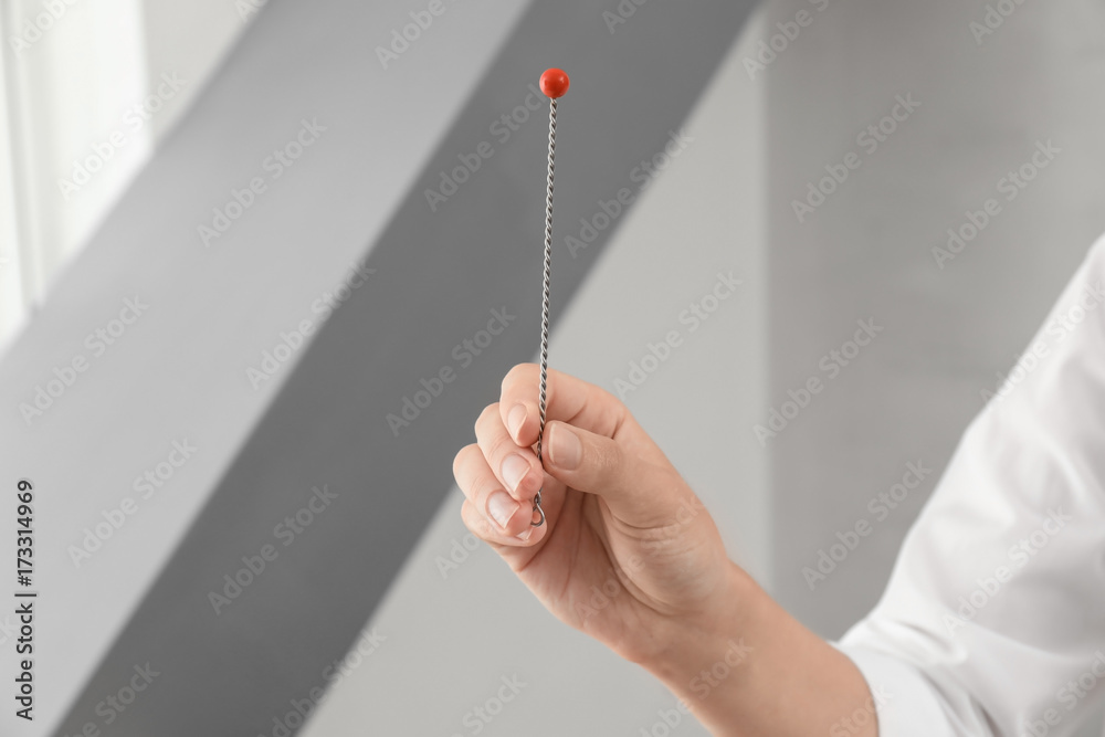 Hand of doctor with logopedic probe for speech correction in clinic ...