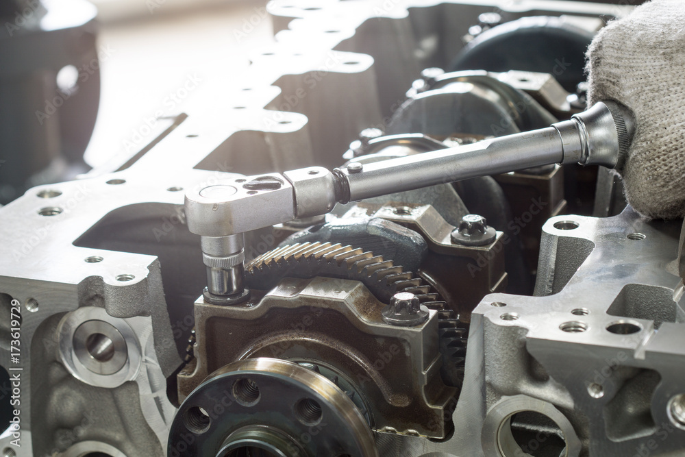 Selective Focus Hand mechanic in gloves tightening the nuts using ...