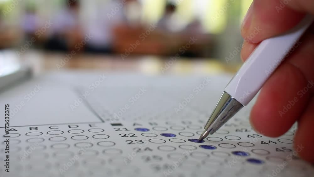 Asian Students holding pencil in hand doing multiple-choice quizzes or ...