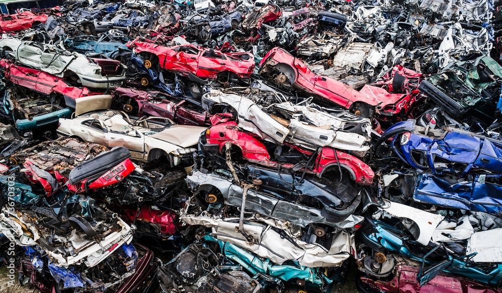 Destroyed scrapped cars stacked on a scrap yard. Stock Photo | Adobe Stock