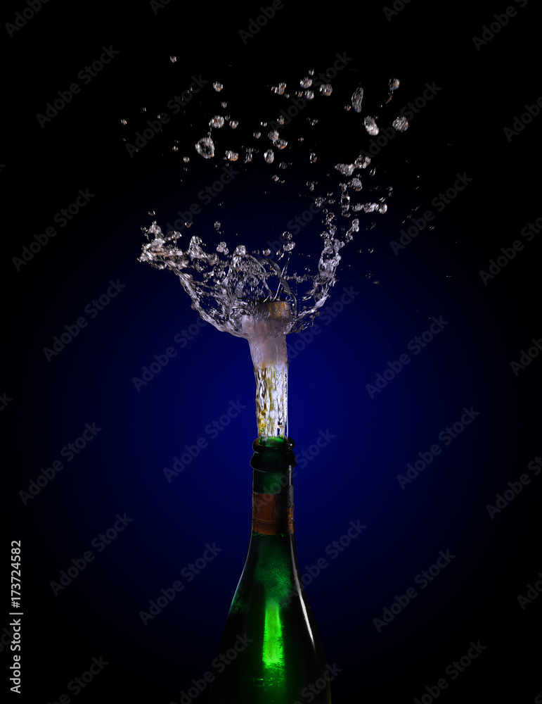champagne bottle explosion with cork popping splash against a dark ...