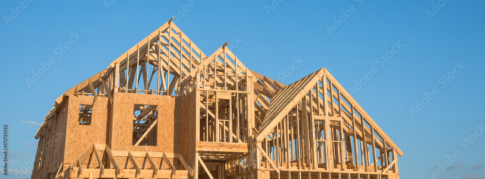 Close-up of gables roof on stick built home under construction and blue ...